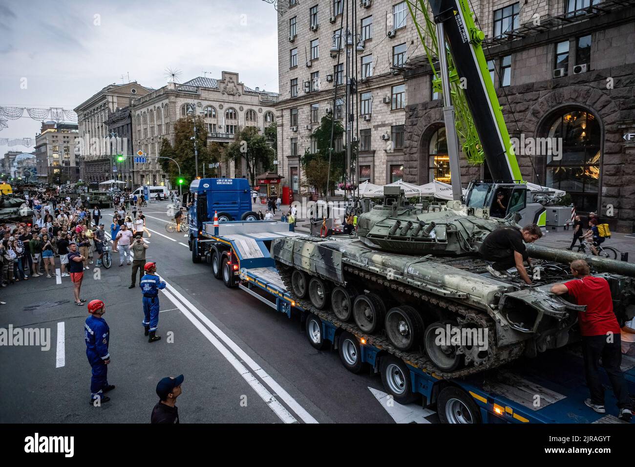 Workers prepare the wreckage of a Russian tank for the exhibition in ...