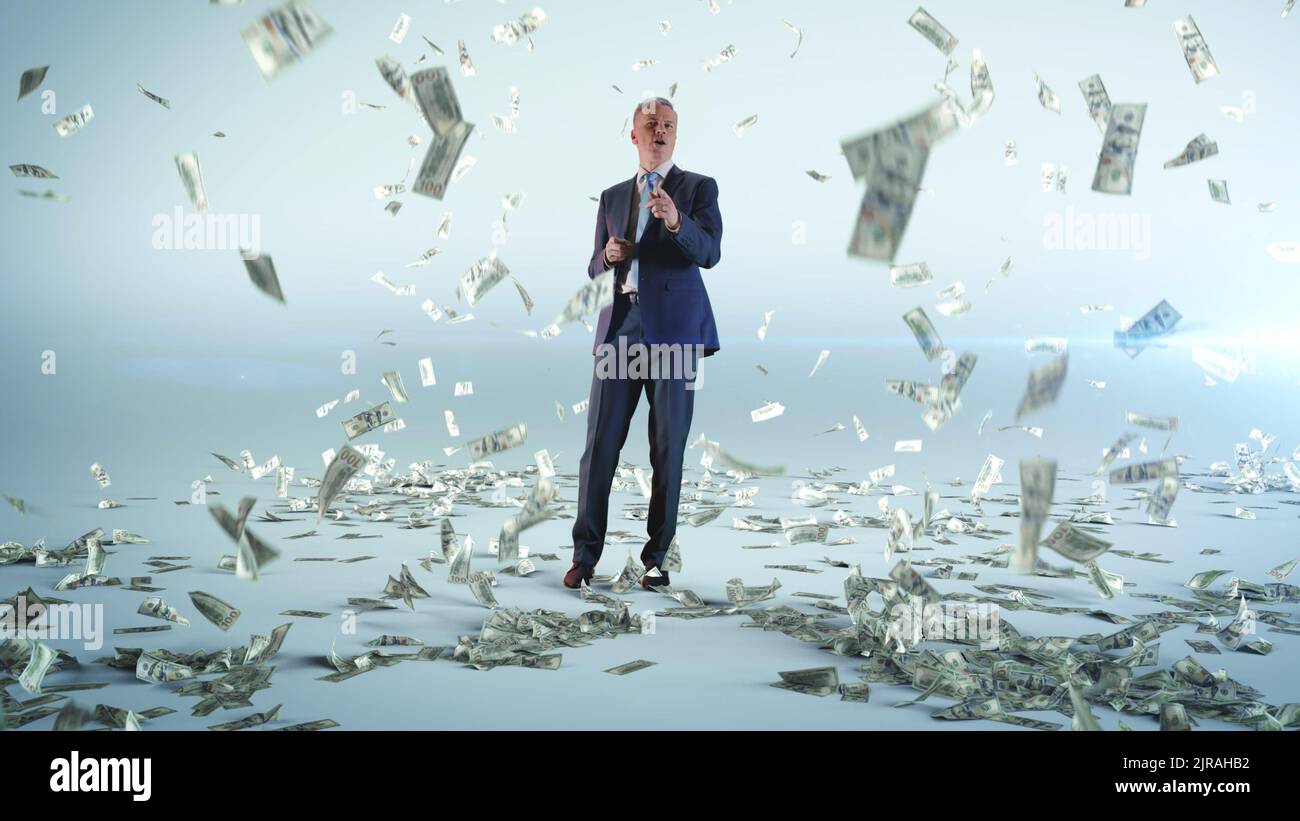 Zoom in view of happy middle aged entrepreneur dancing under falling ...