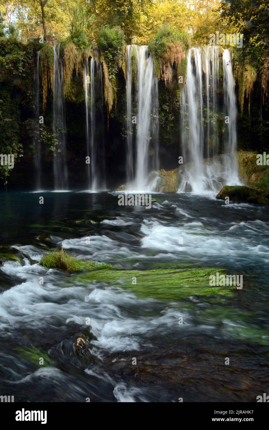 Slow exposure waterfall with swirling greenery and cloud like water ...