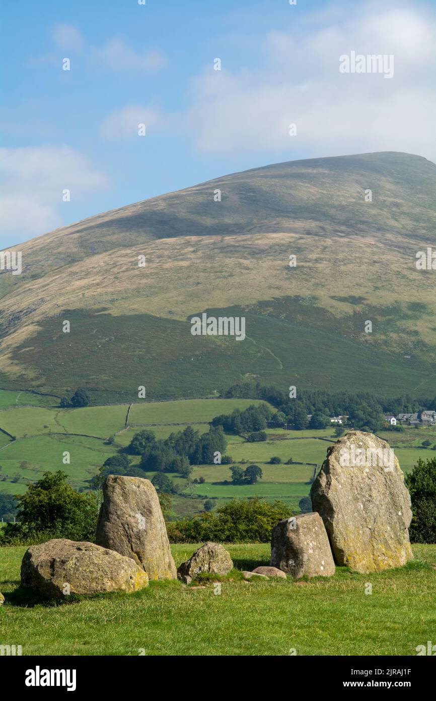 Standing stones in the English countryside. Lake district mountains in ...