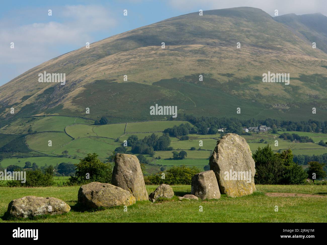 Standing stones in the English countryside. Lake district mountains in ...