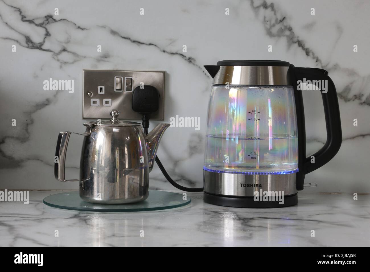 An Electic Kettle on kitchen work surface with wather being boiledThe ...