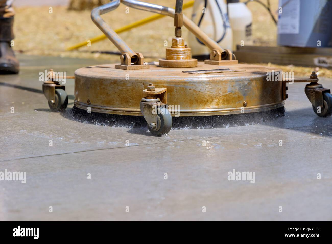 The worker cleaned the pavement with a sweeper machine as part of his ...