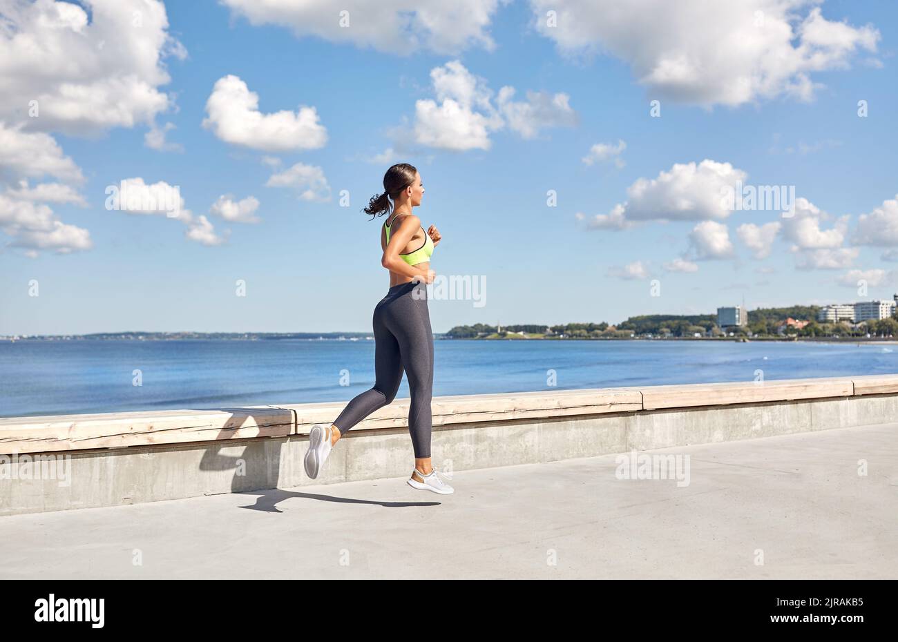 Beautiful young woman running sea hi-res stock photography and images ...