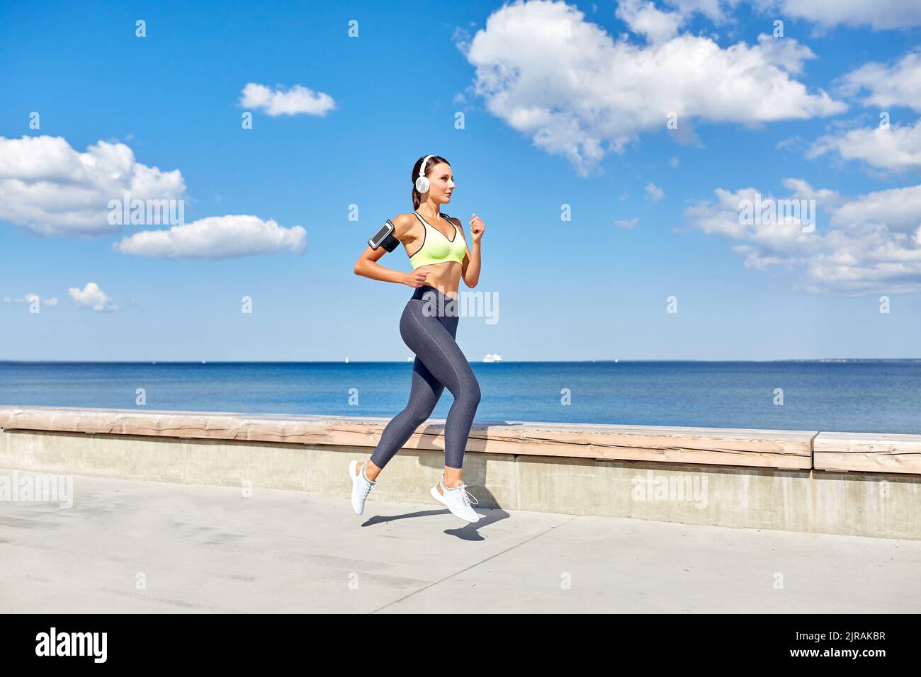 Woman running with headphones hi-res stock photography and images - Alamy