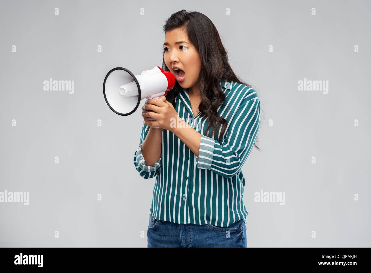 angry young asian woman speaking to megaphone Stock Photo - Alamy