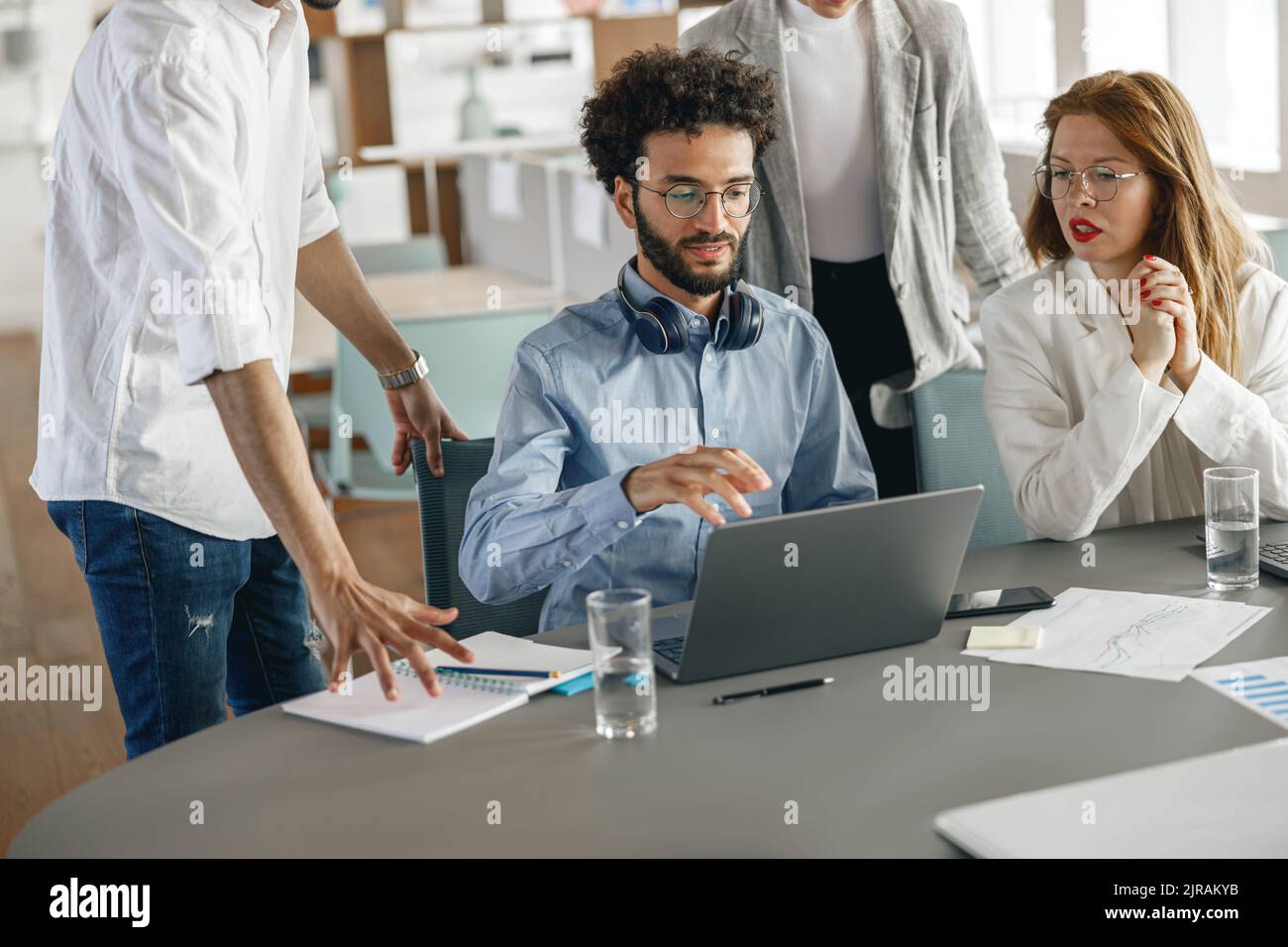 Busy coworkers cooperating and working together at office meeting ...