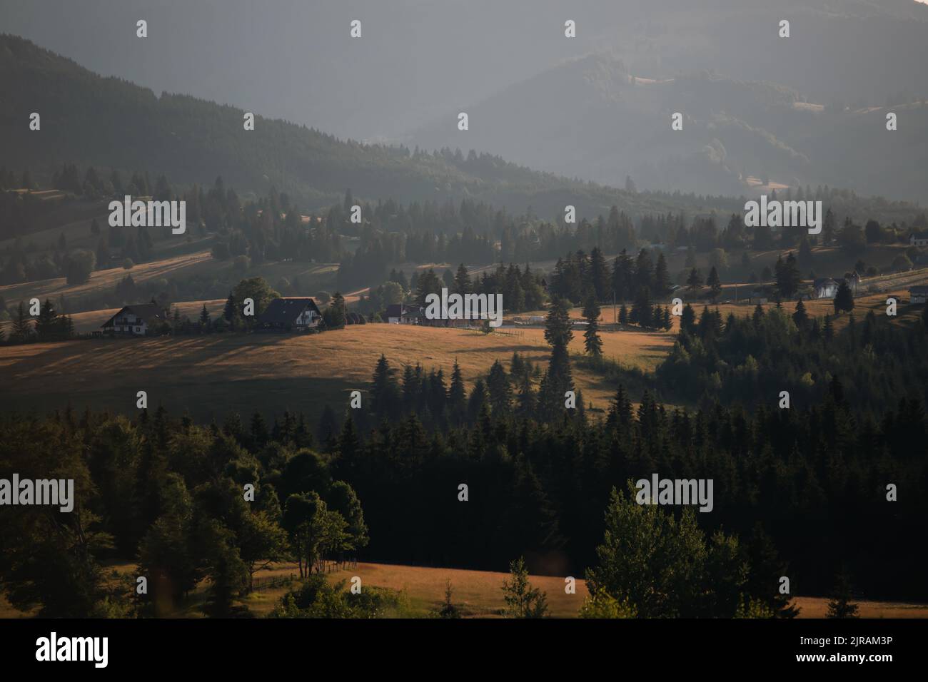 Magic summer sunset over the mountain village at Tihuta, Piatra ...
