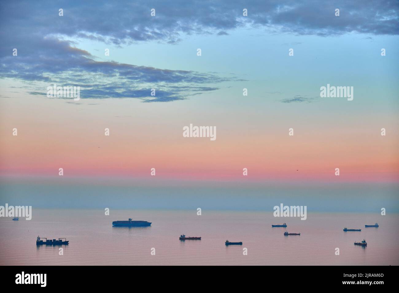the plane flies over the ships into the sea Stock Photo - Alamy