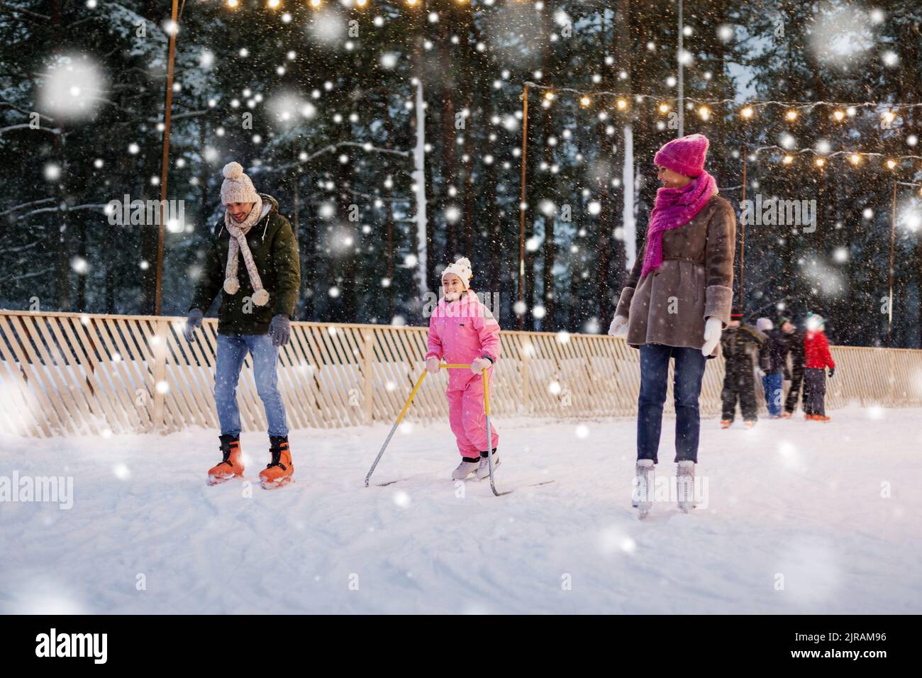 happy family at outdoor skating rink in winter Stock Photo - Alamy