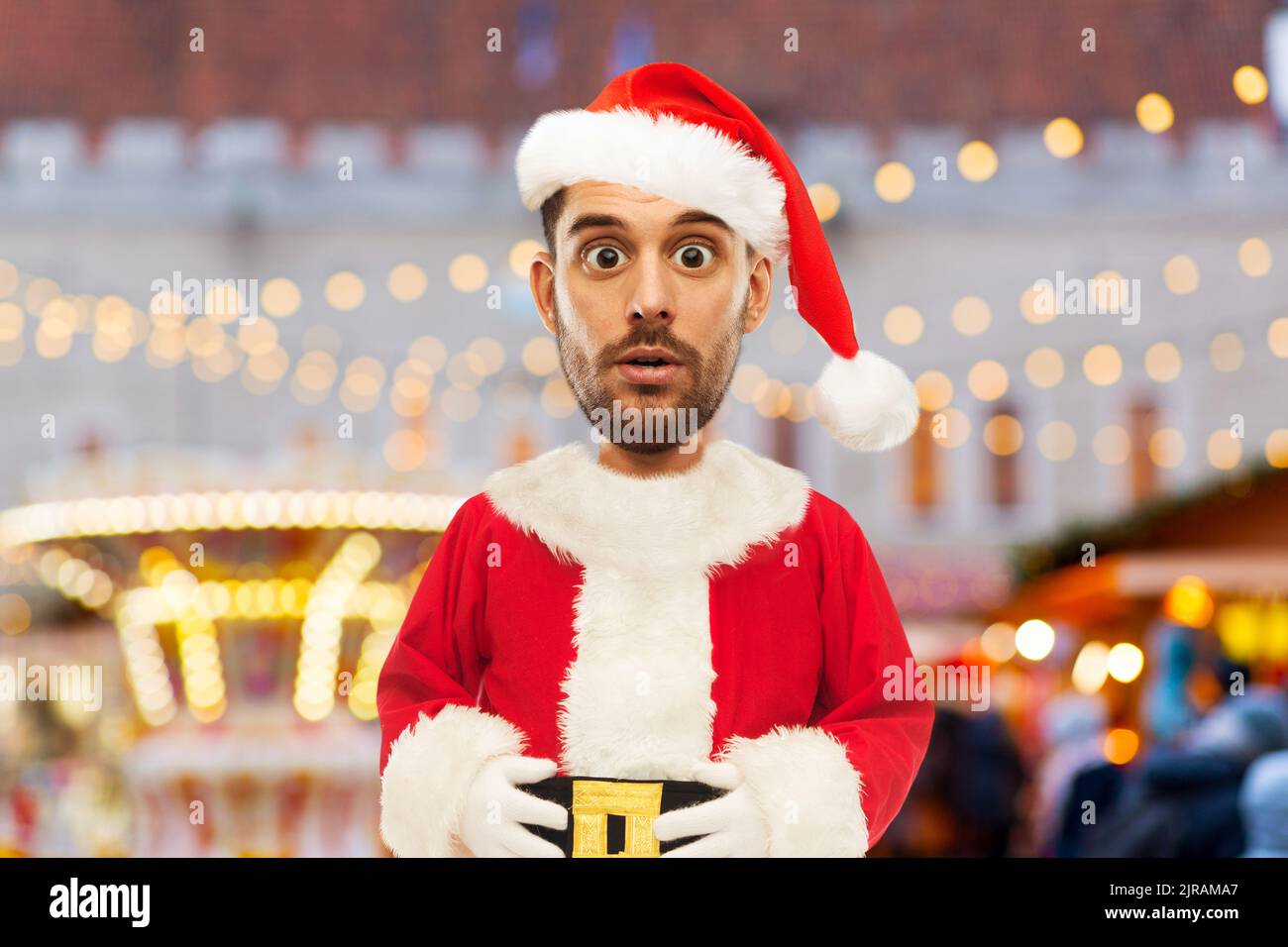 surprised man in santa costume at christmas market Stock Photo - Alamy