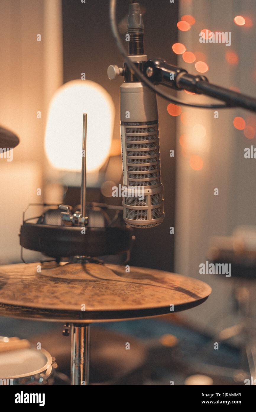 A vertical shot of a studio microphone with stand in the blurred ...