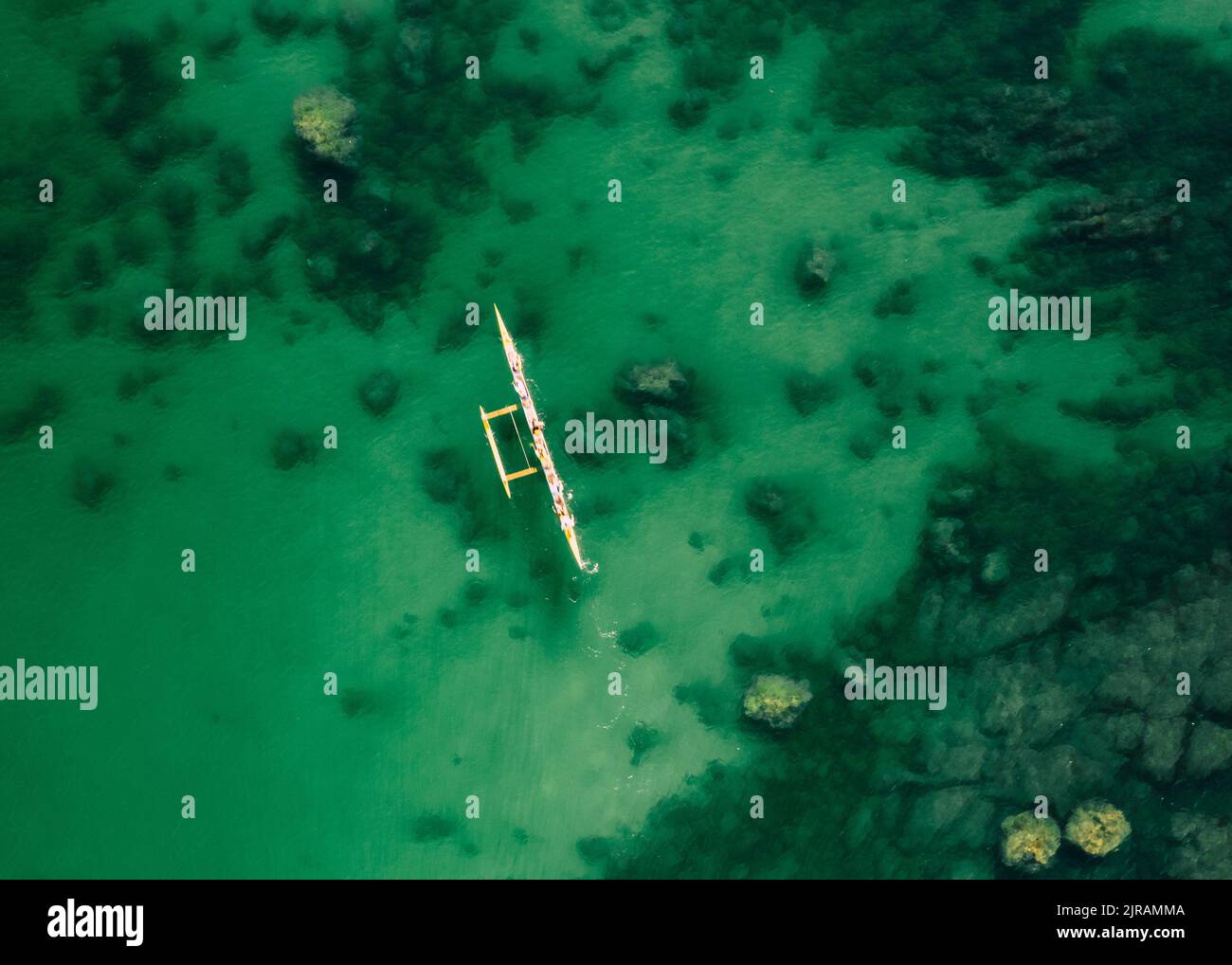 A bird's eye view of a canoe rowing in the green sea Stock Photo - Alamy