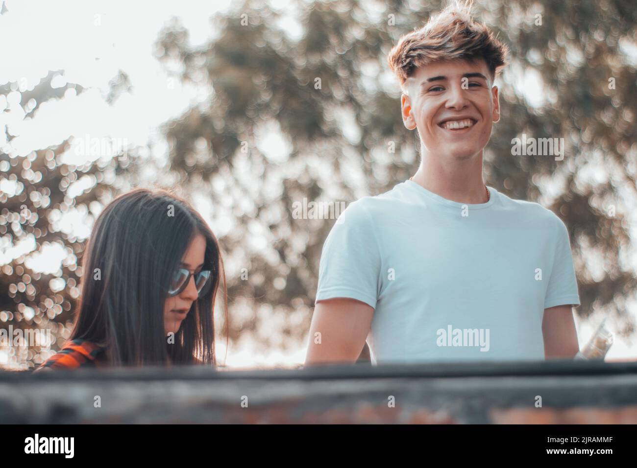 Two young Spanish friends spending time together while cooking in a ...