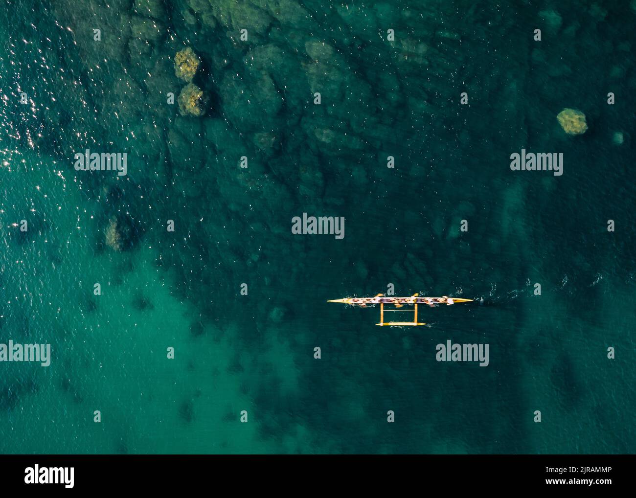 A bird's eye view of a canoe rowing in the blue sea Stock Photo - Alamy