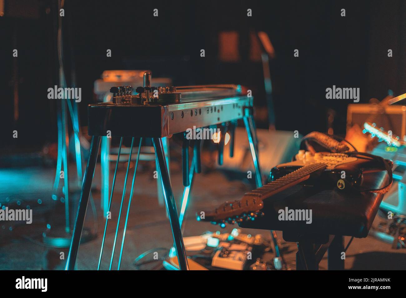 A closeup of musical instruments with blue lights on in the dark ...