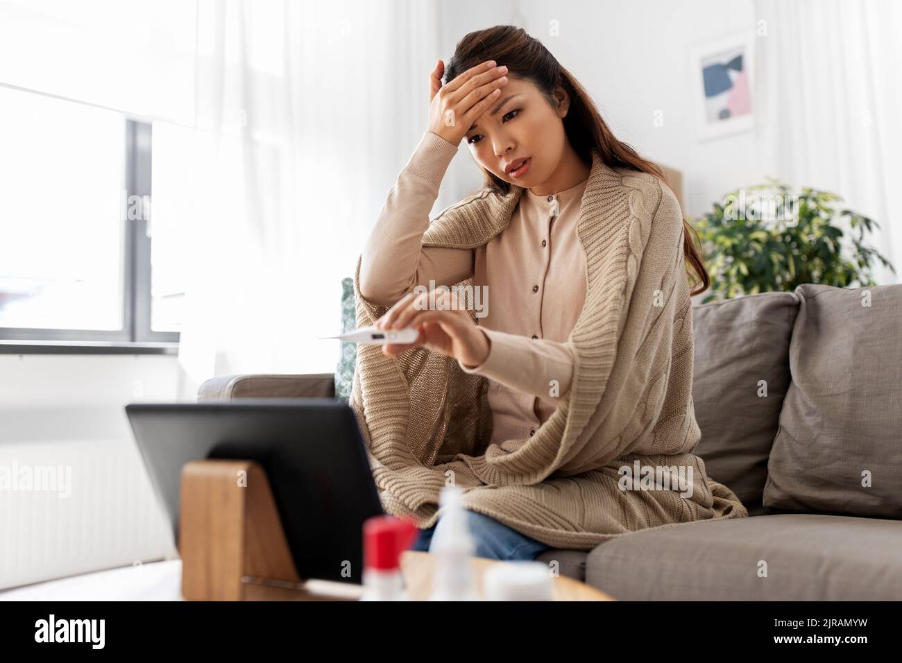 sick woman having video call on tablet computer Stock Photo - Alamy