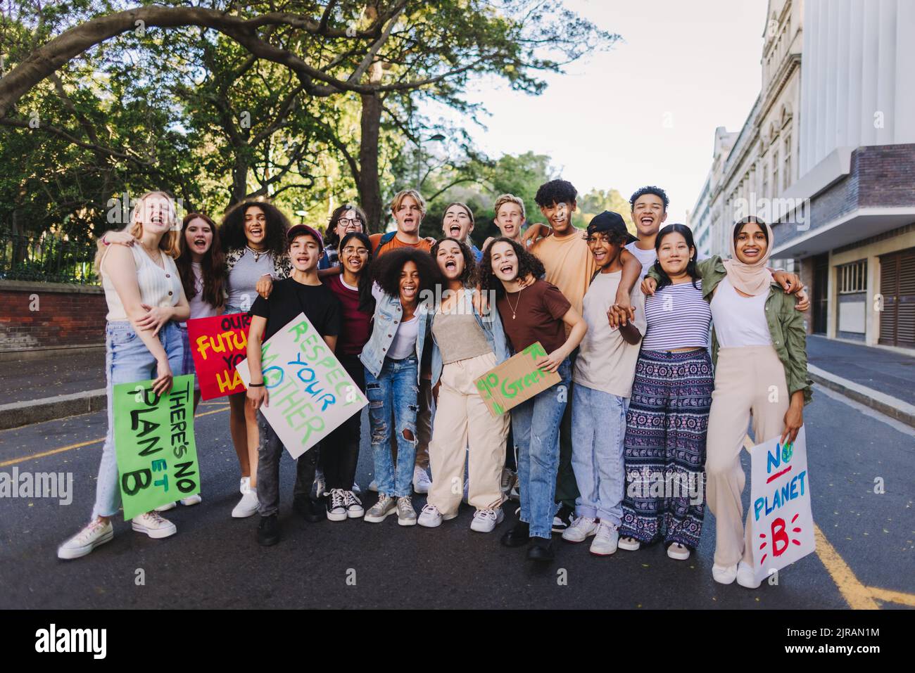 Group of multiethnic teenagers smiling at the camera while standing ...
