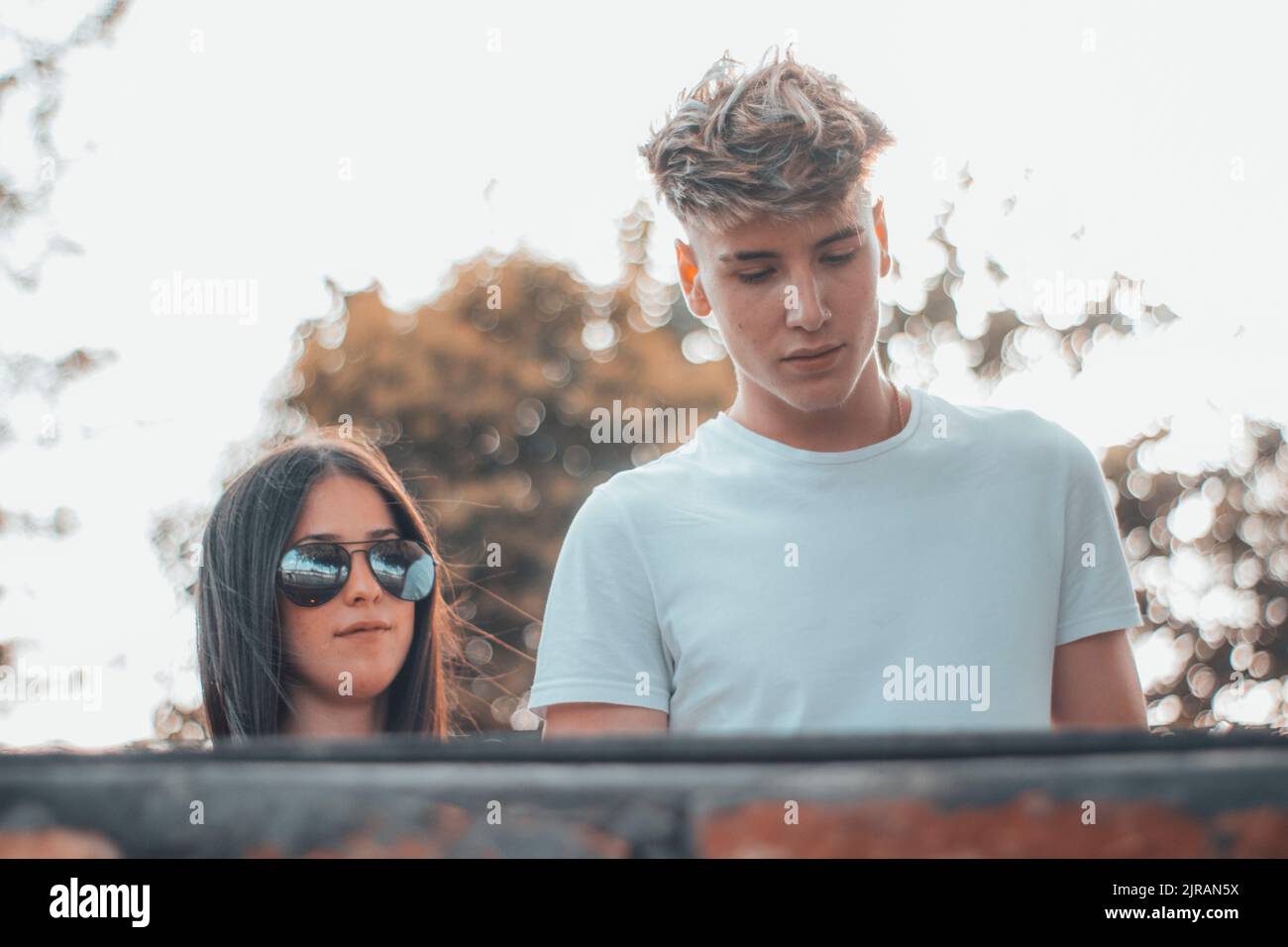 Two young Spanish friends spending time together while cooking in a ...