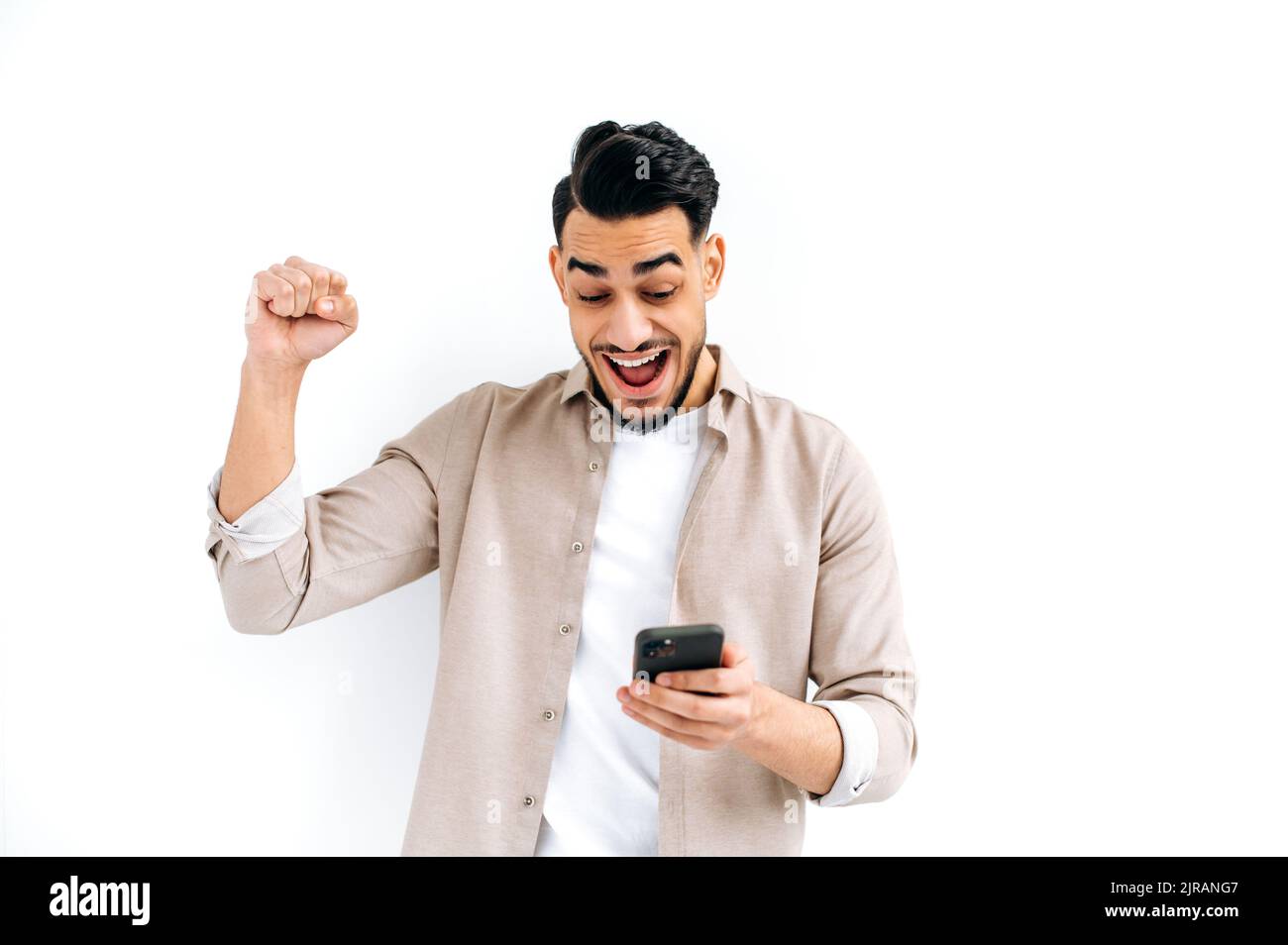 Win, victory, triumph. Joyful amazed excited indian or arabian young ...