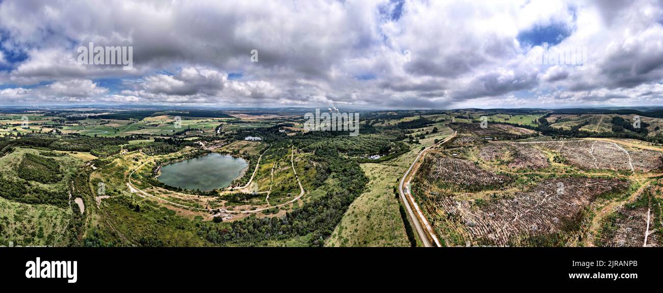 A panoramic drone shot overlooking a lake, farmland, and forest Stock ...