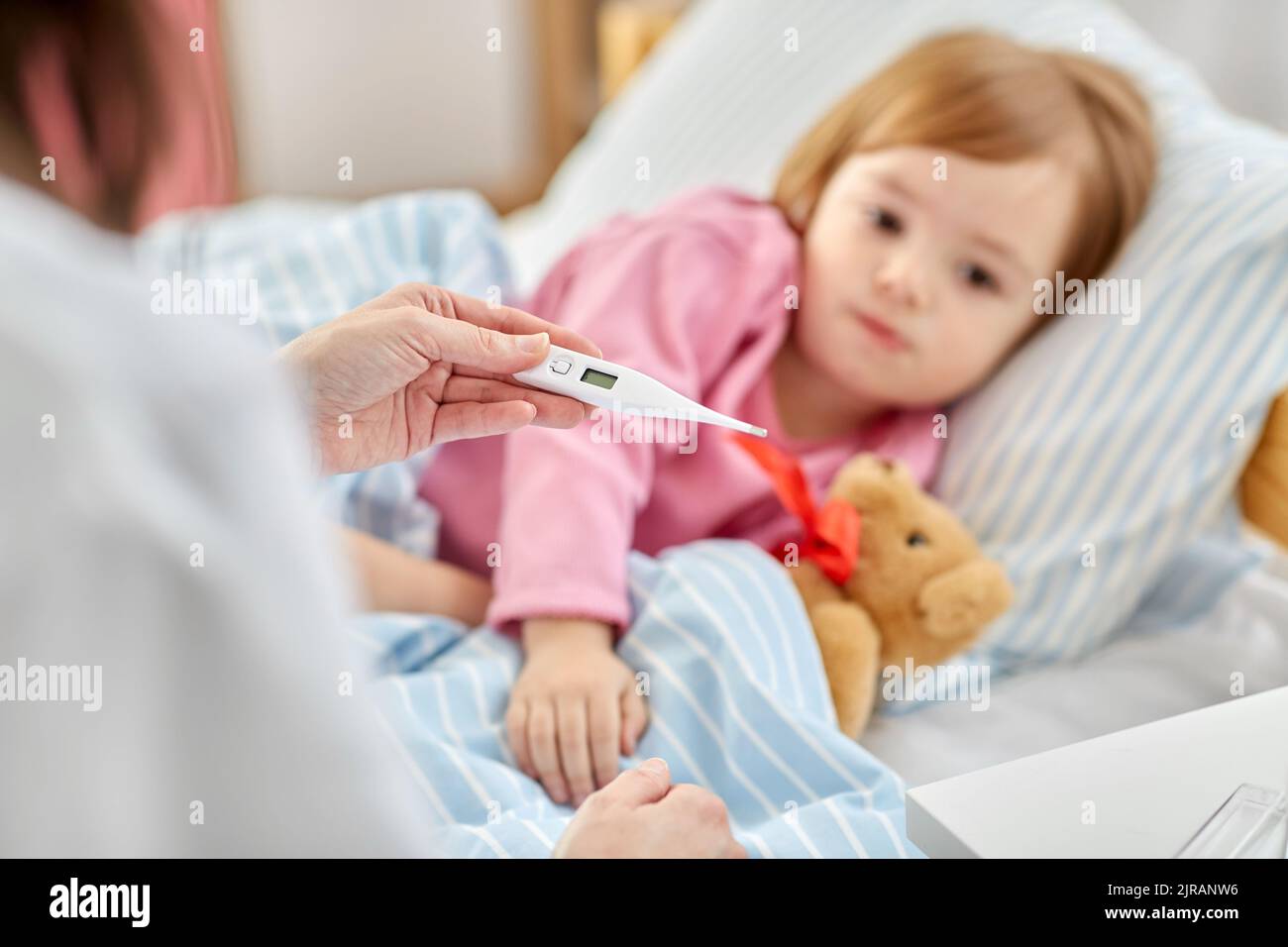 doctor measuring sick girl's temperature Stock Photo - Alamy