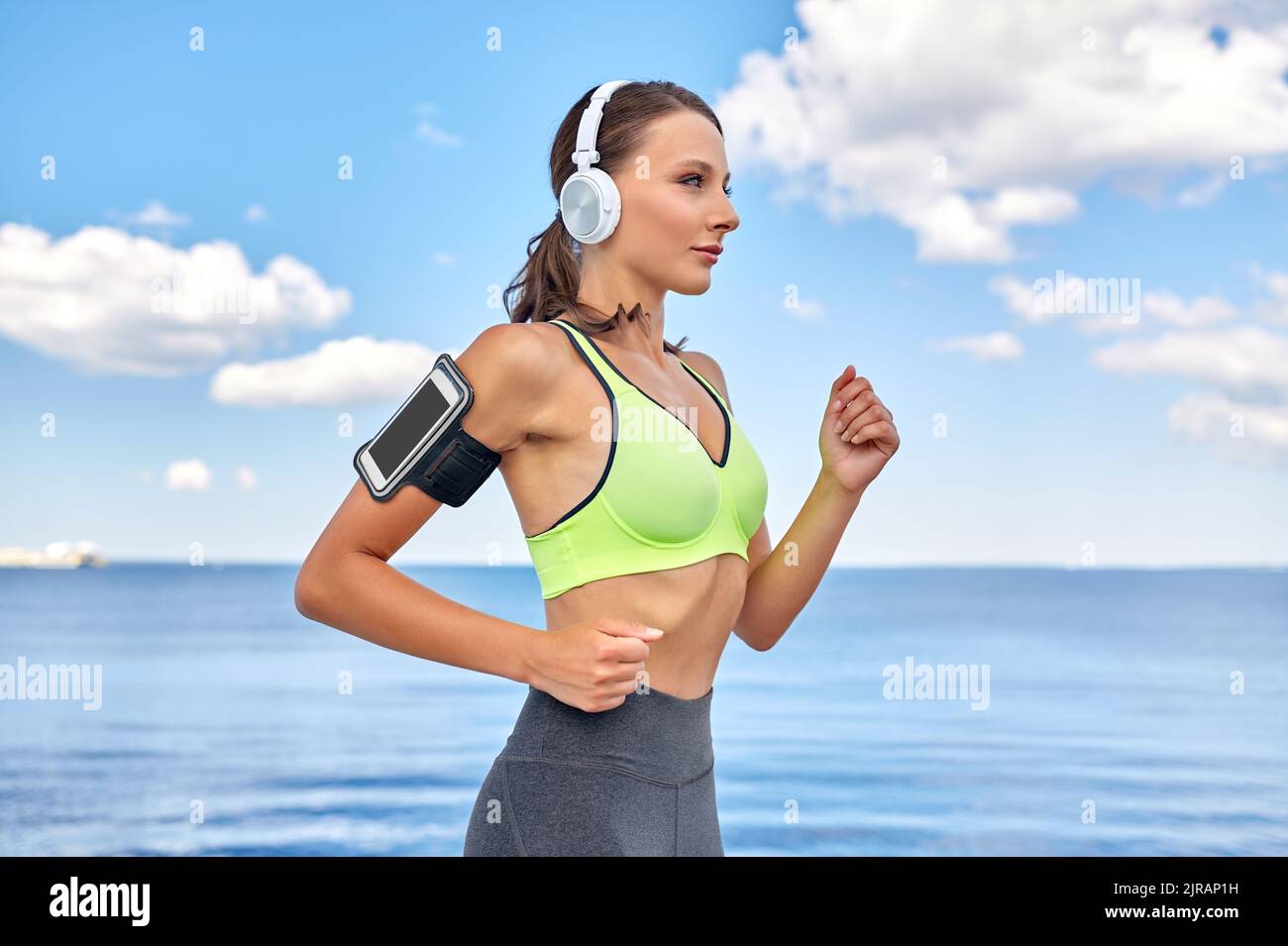 Woman headphones smartphone running hi-res stock photography and images ...