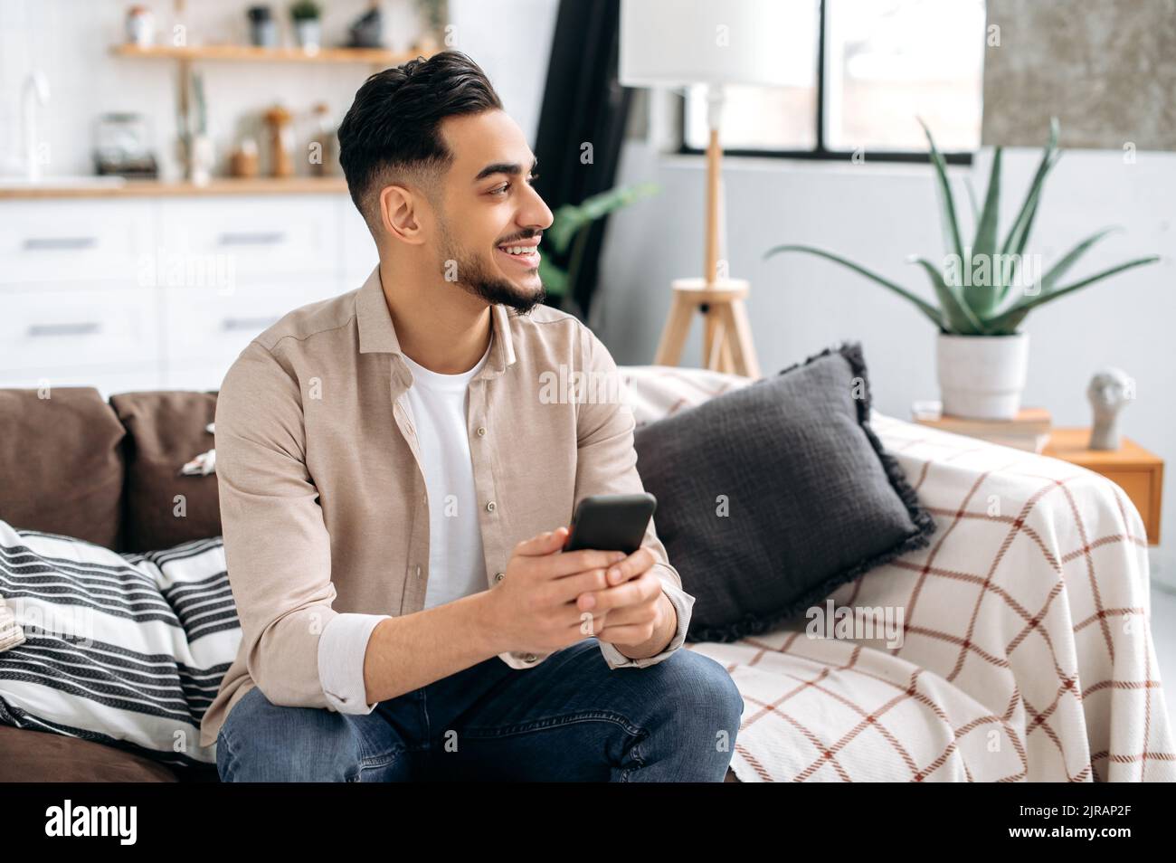 Positive arabian man texting phone hi-res stock photography and images ...