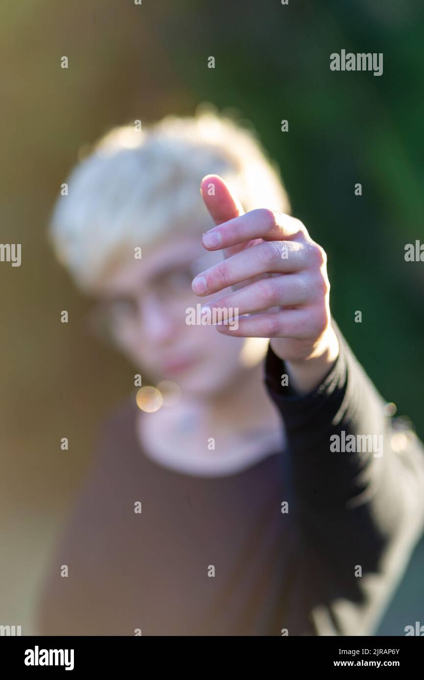 A vertical closeup of a girl holding out her hand Stock Photo - Alamy