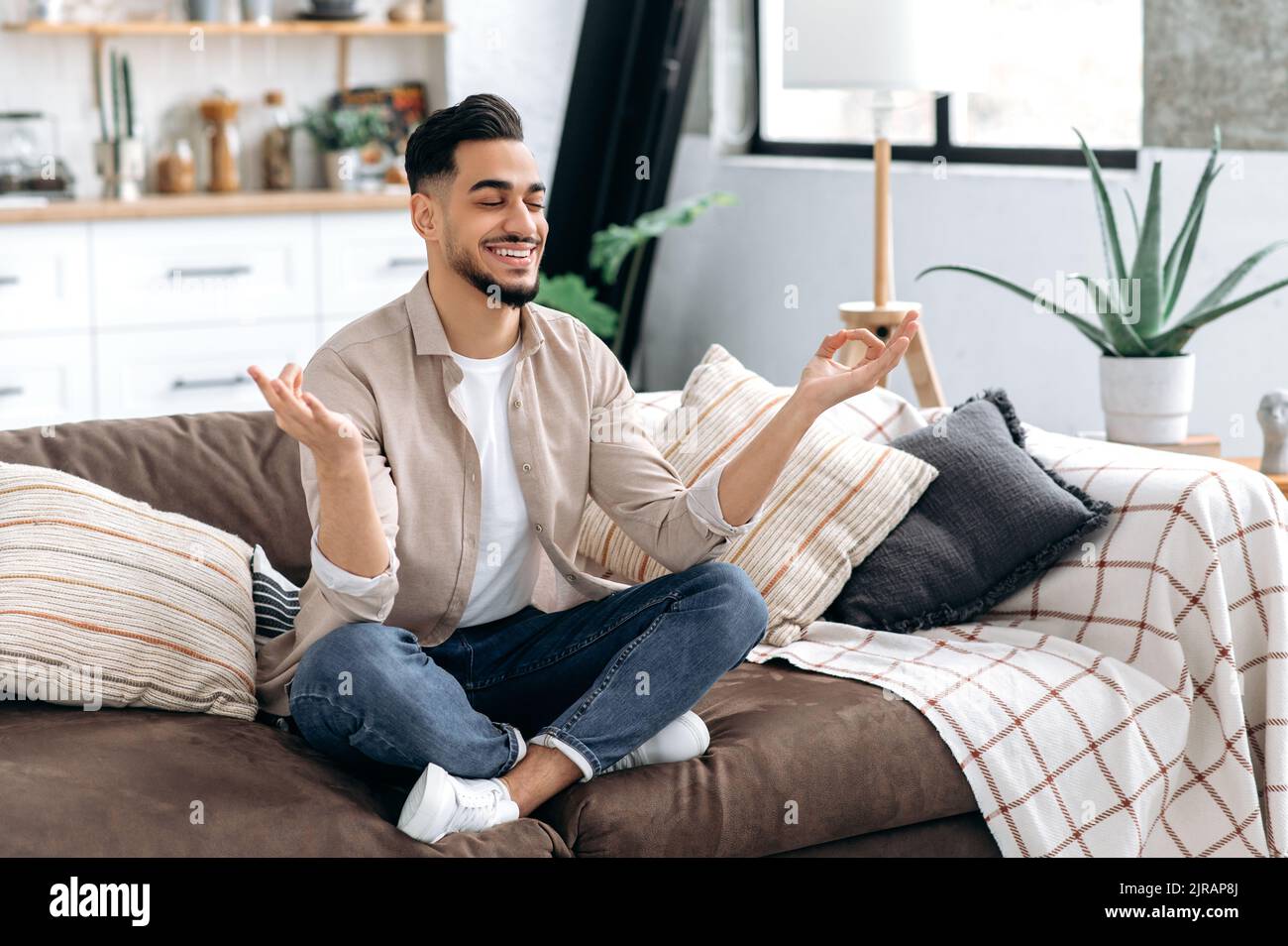 Chilling and relaxing at home. Happy positive calm relaxed indian or ...