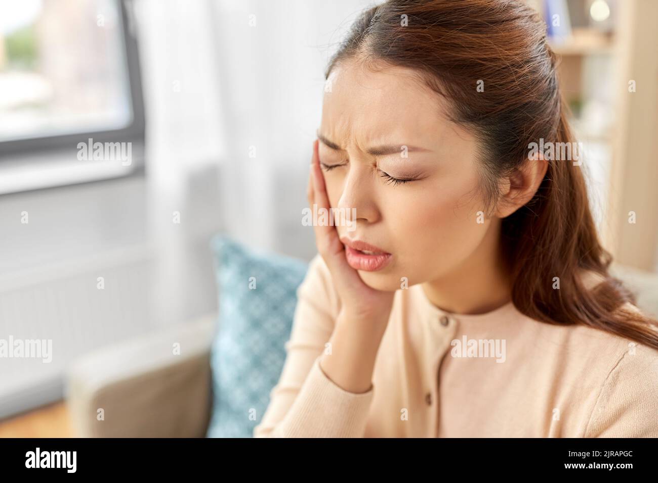 asian woman suffering from toothache at home Stock Photo - Alamy
