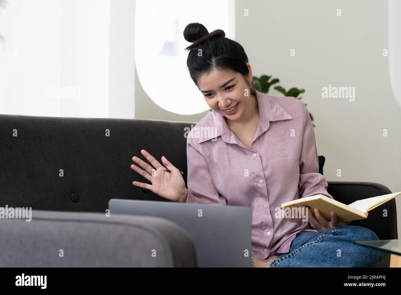 Asia woman using laptop talk to colleagues about plan in video call ...