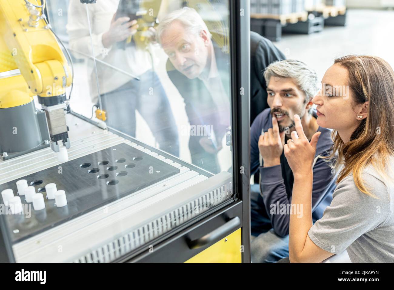 Technicians testing and observing new industrial robot Stock Photo - Alamy