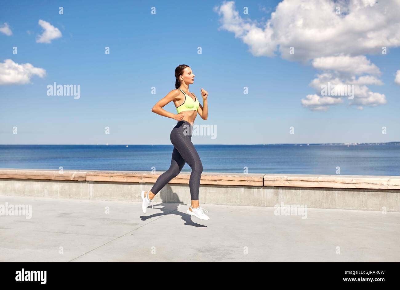 Beautiful young woman running sea hi-res stock photography and images ...