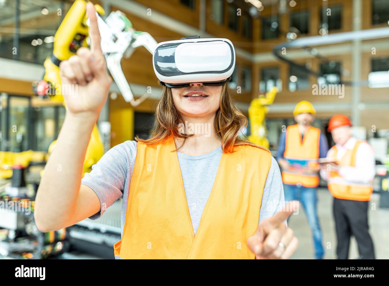 Industrial worker in robotics factory using virtual reality simulator Stock Photo - Alamy