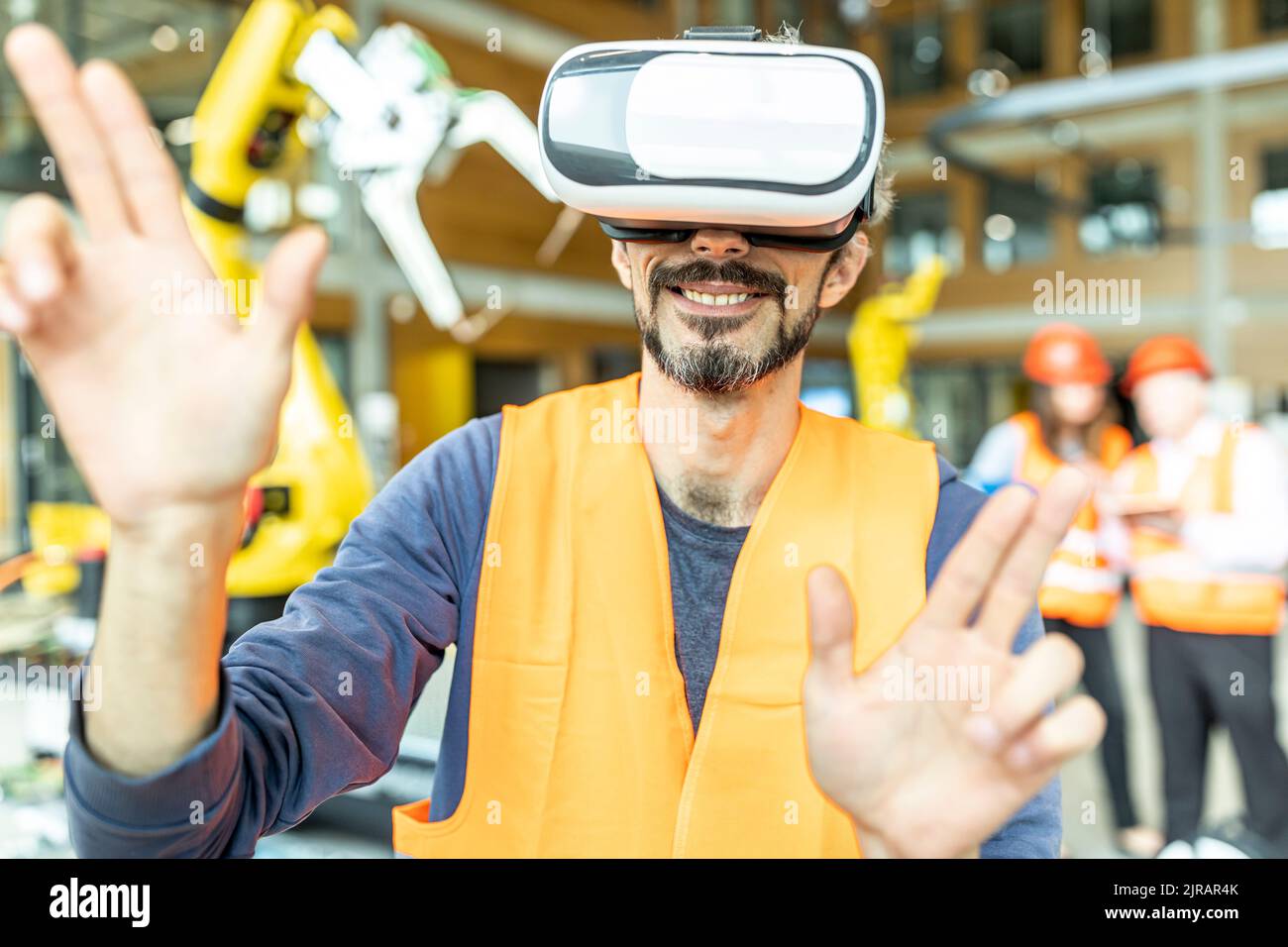 Industrial worker in robotics factory using virtual reality simulator Stock Photo - Alamy