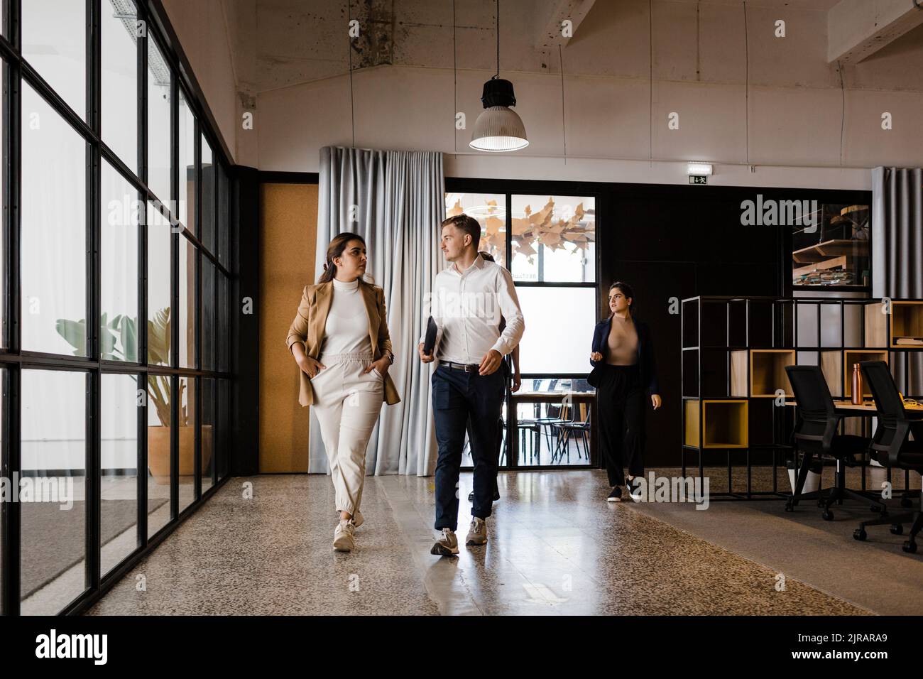 Business colleagues walking together in modern office Stock Photo - Alamy