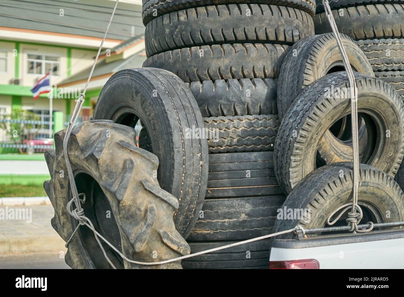 An overloaded pickup truck carrying used rubber tires for recycling ...