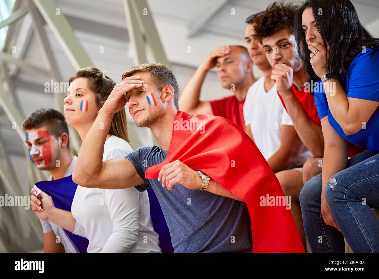 Worried fans watching sports event at stadium Stock Photo - Alamy