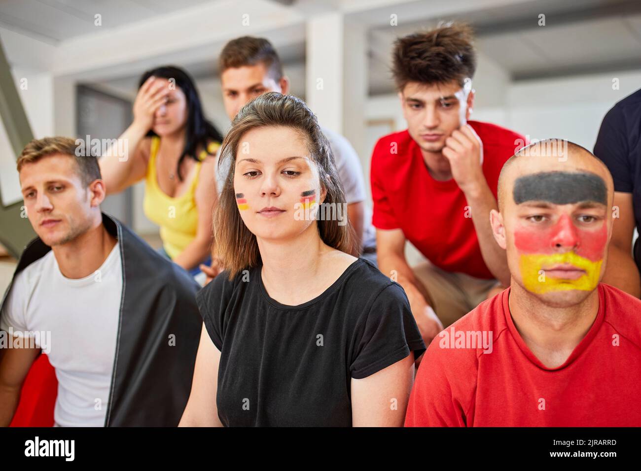 Serious fans sitting together watching sports event in stadium Stock ...