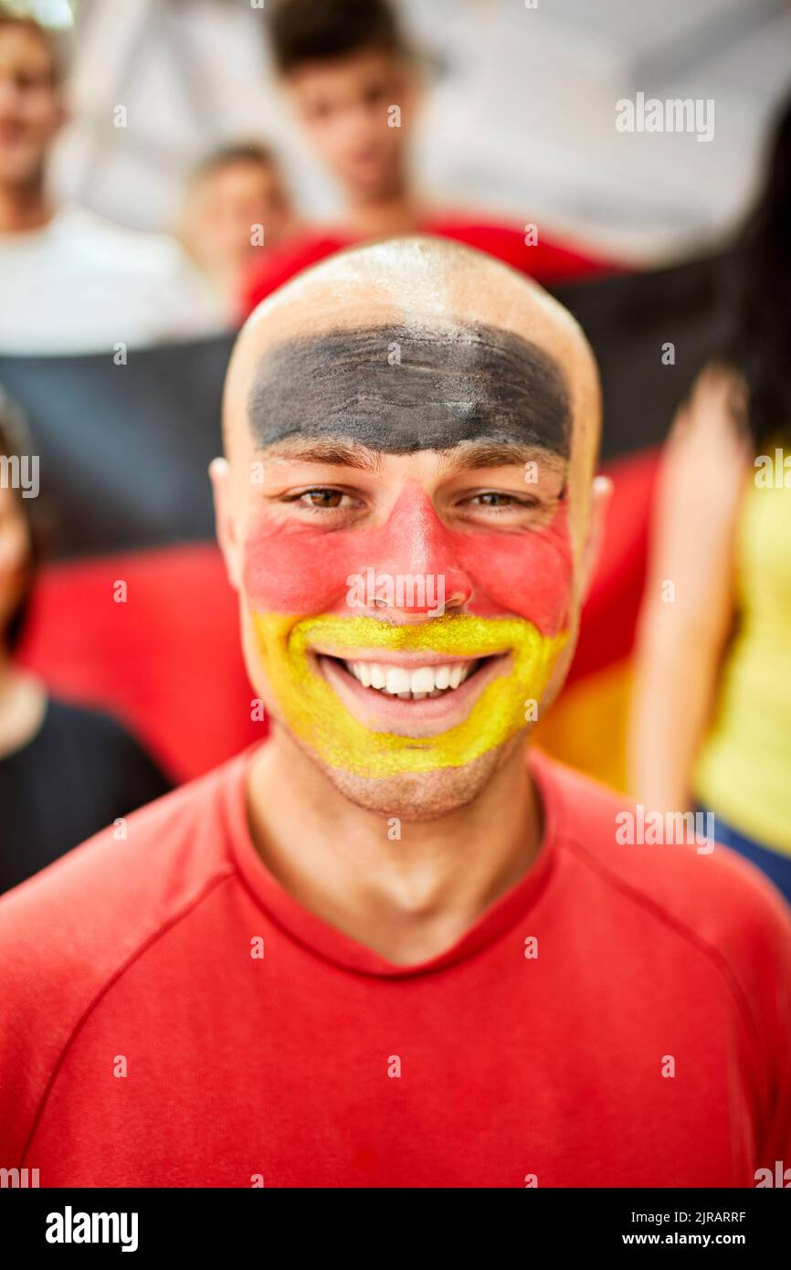 Young smiling man with German Flag painted of face at stadium Stock ...