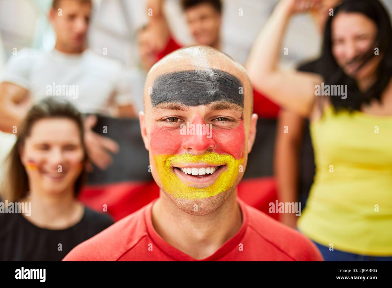 Happy man with German Flag painted on face at stadium Stock Photo - Alamy
