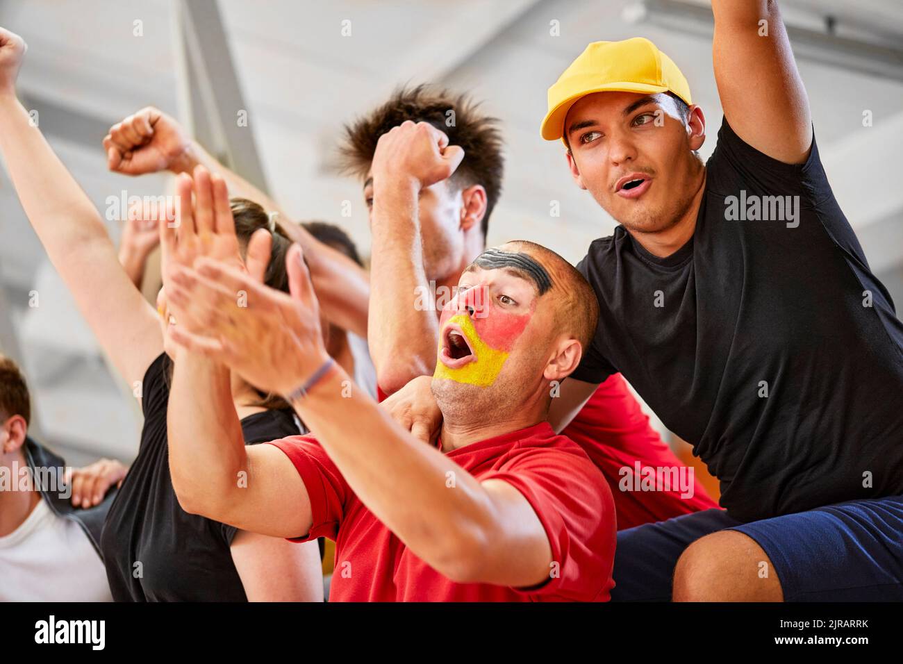 Friends cheering together at sports event in stadium Stock Photo - Alamy