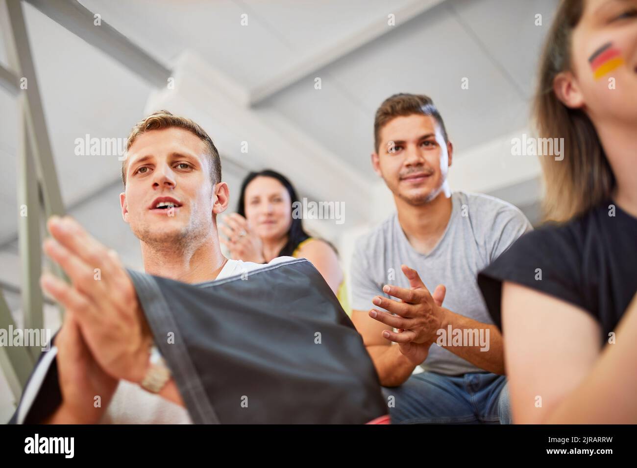 Fans applauding at sports event in stadium Stock Photo - Alamy