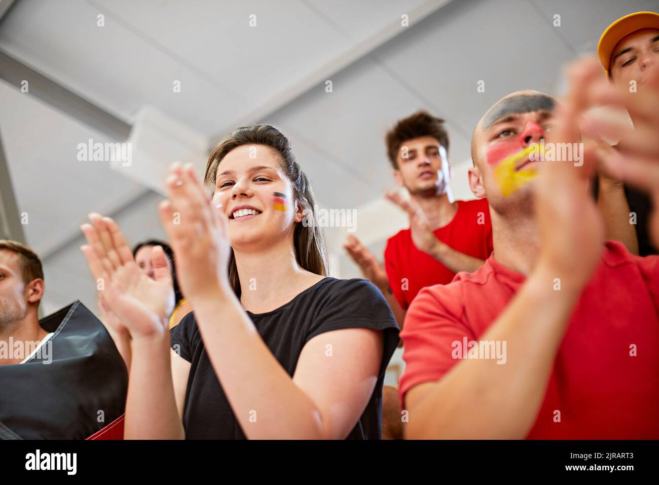 Friends clapping together watching sports event in stadium Stock Photo ...