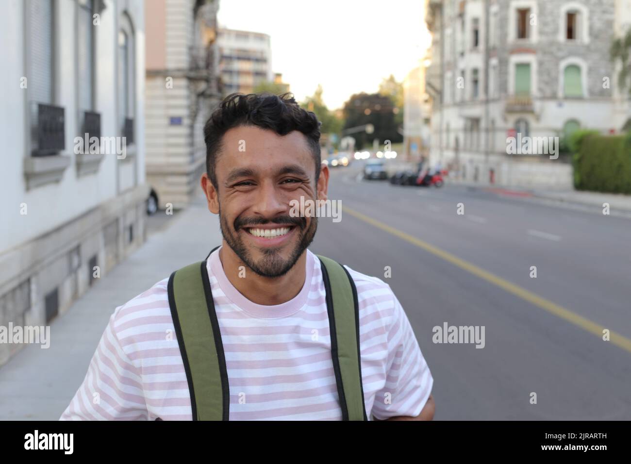 Handsome adult student with backpack outdoors Stock Photo - Alamy