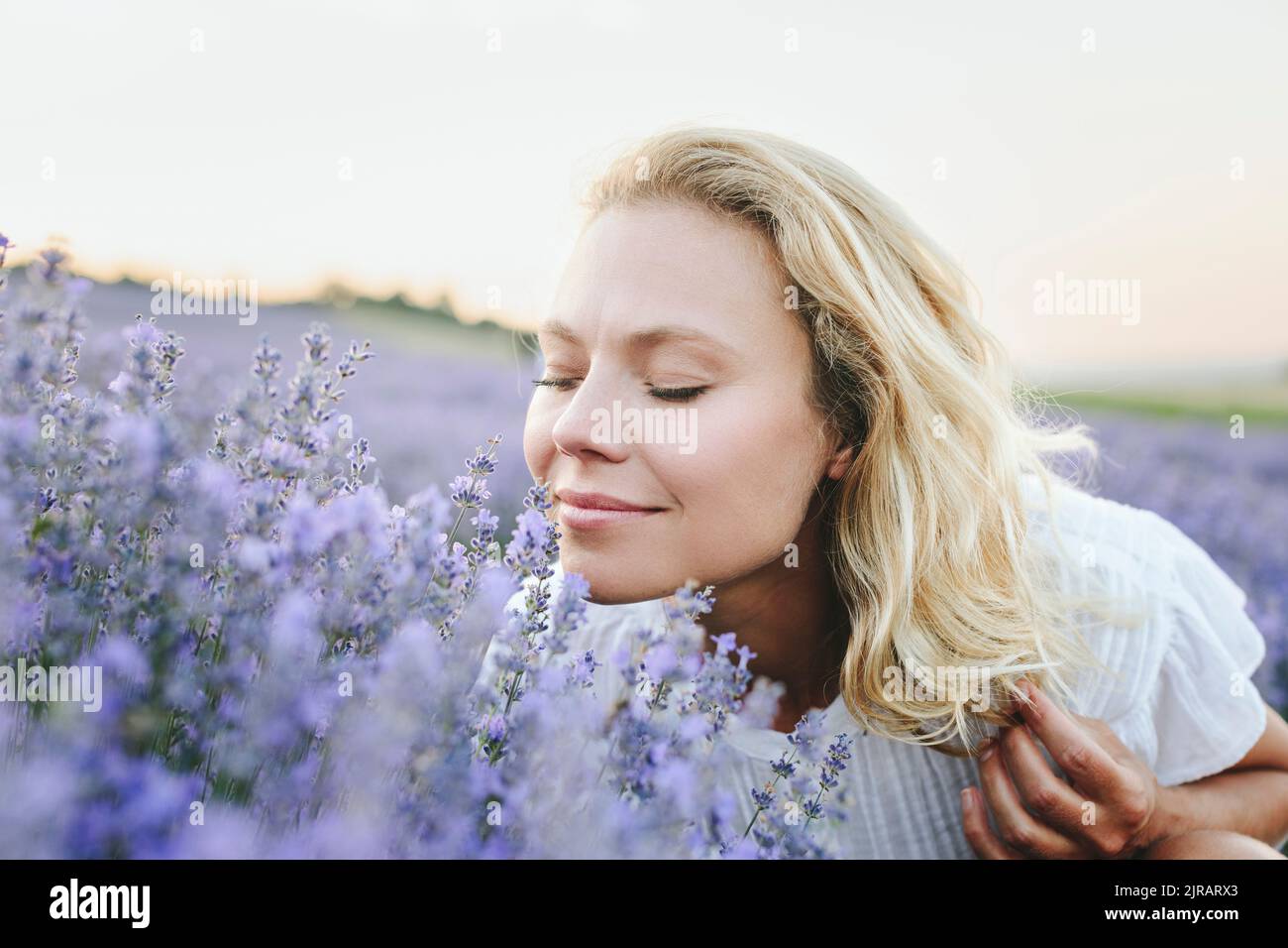 Woman smelling lavender flowers hi-res stock photography and images - Alamy