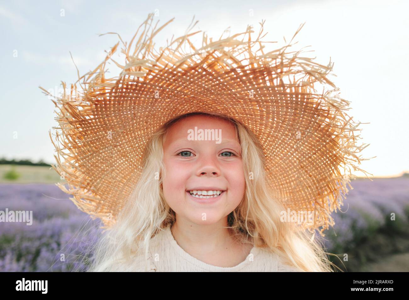 Happy girl wearing straw hat standing in lavender field Stock Photo - Alamy