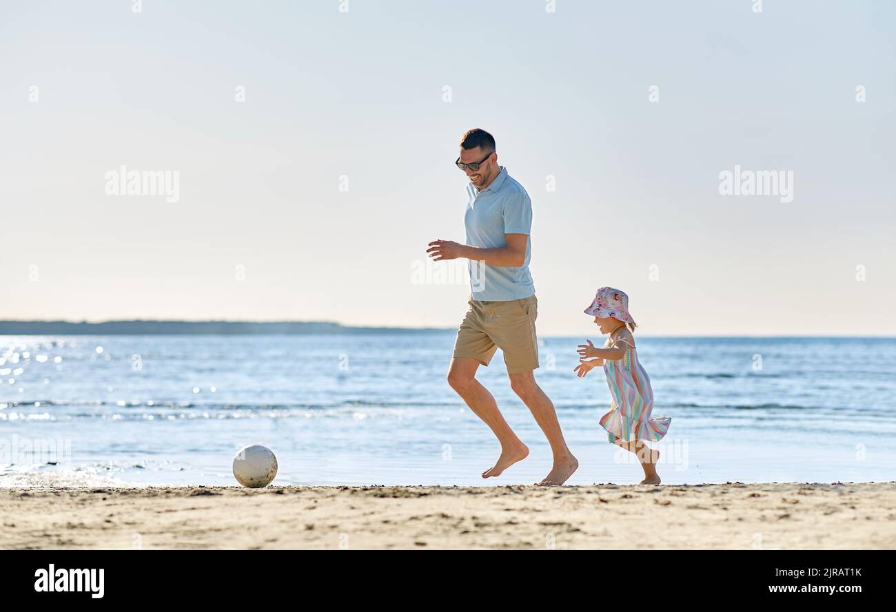 Happy baby girl playing with father on the beach hi-res stock ...