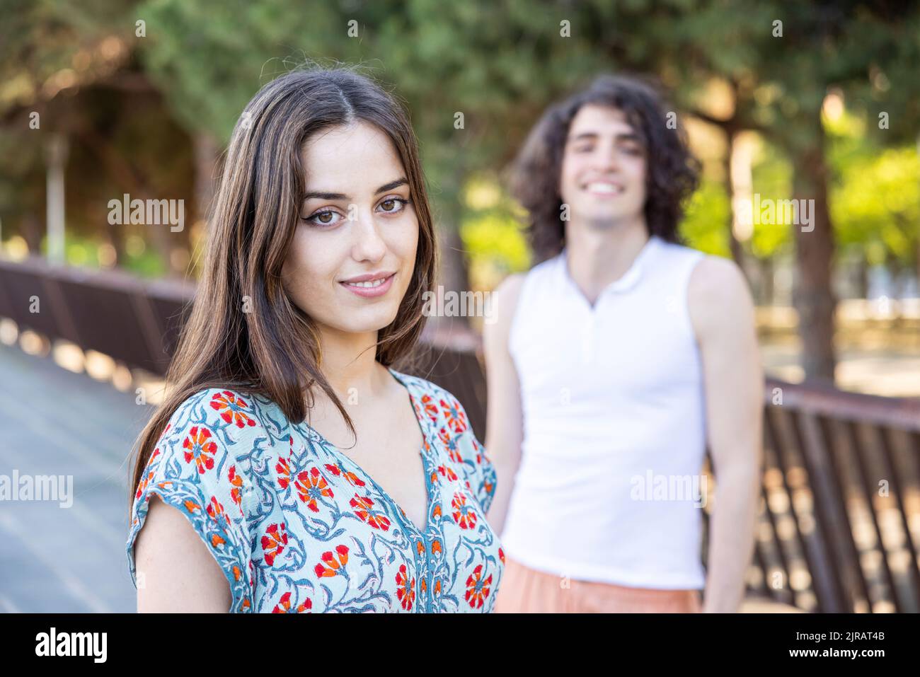 Young girlfriend standing in front of boyfriend at park Stock Photo - Alamy